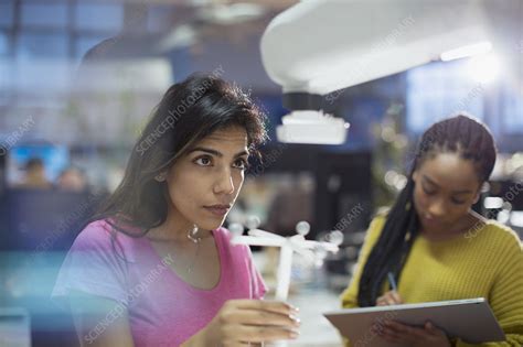 Female Engineers Testing Robotic Arm In Office Stock Image F028