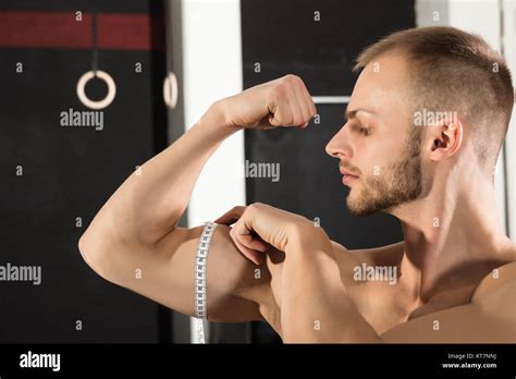 Man Measuring Arm With Tape Measure Stock Photo Alamy