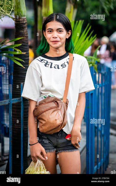 A Beautiful Young Filipino Girl Sells Flower Garlands Outside The St