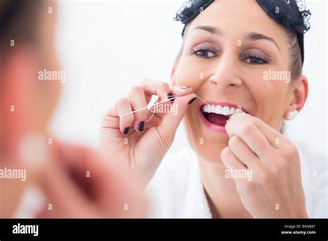 Woman Cleaning Teeth With Dental Floss Stock Photo Alamy