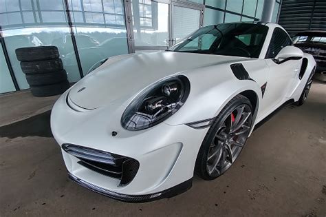 전용 와이드 및 카본 바디 키트의 독점 화이트 매트 포 르 쉐 911 터보는 톱 카 튜닝에서 Stinger 라는 거리에 주차 프론트 사이드 후드 뷰 Porsche 911에