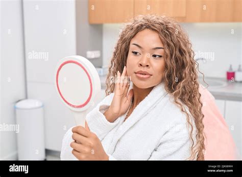 Woman Admiring Her Reflection In The Mirror Stock Photo Alamy