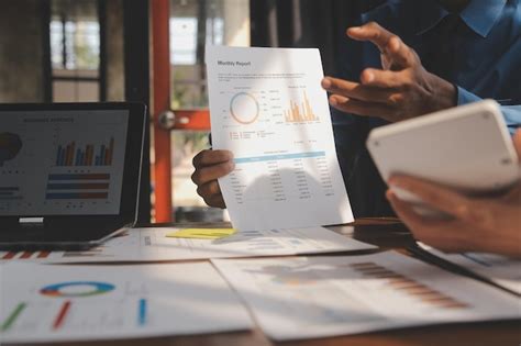 Premium Photo Close Up Of Business Team Analyzing Income Charts And Graphs With Modern Laptop