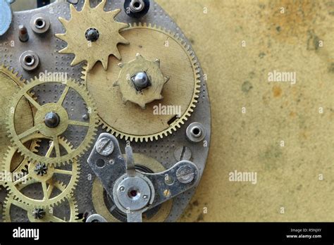 Closeup Of Old Metal Clock Mechanism On Yellow Brass Background Stock Photo Alamy