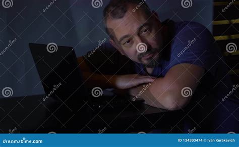 A Man Hacker In A Dark Room Fell Asleep Near The Computer Works With The Program Code Concept