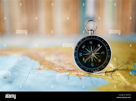Compass On The Map And Book In The Background In The Area Of Confusion