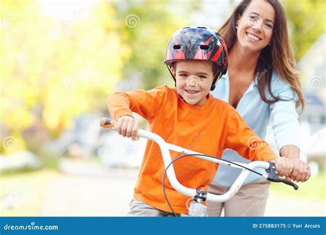Mom Wont Let Him Fall A Young Mother Teaching Her Son How To Ride A