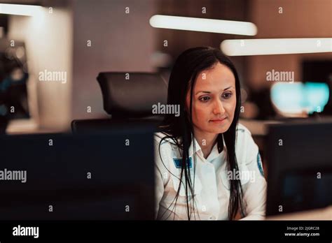 Female Security Operator Working In A Data System Control Room Offices Technical Operator