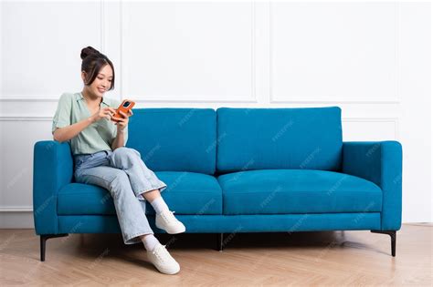 Premium Photo Image Of Young Asian Girl Sitting On Sofa At Home