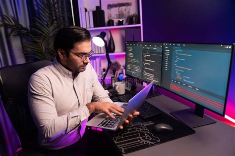It Developer Working Laptop To Search Code System At Neon Light Office