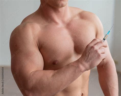 Close Up Of A Male Torso Unrecognizable Shirtless Bodybuilder Man Puts Himself An Injection Of