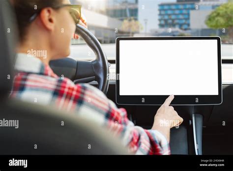 Female Driver Interacts With The Digital Control Screen In A Modern Car Mockup Of Blank Screen
