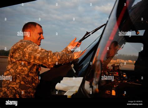 U S Army Sgt Matthew Larsen 7th Battalion 158th Aviation Regiment Cleans The Windows Of A