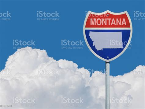 Highway Sign For Interstate Road In Montana With Map In Front Of Clouds