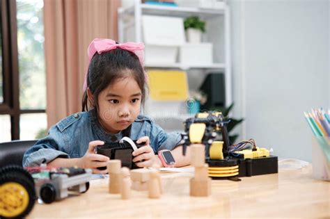 A Young Girl Is Playing With A Remote Control A Robot Stock Image Image Of Science Technology