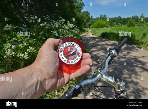 The Compass And The Bike Magnetic Compass In The Hand And The