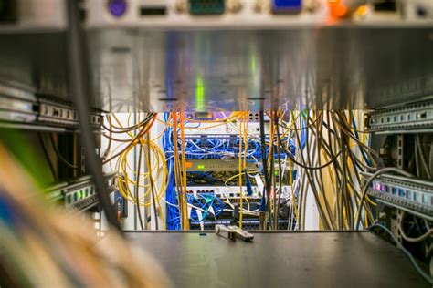Many Tangled Wires Are On Top Of The Server Racks Of The Data Center