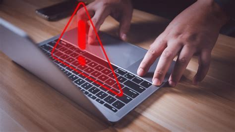 Premium Photo Hacker Or Programmer Using Laptop With Triangle Caution