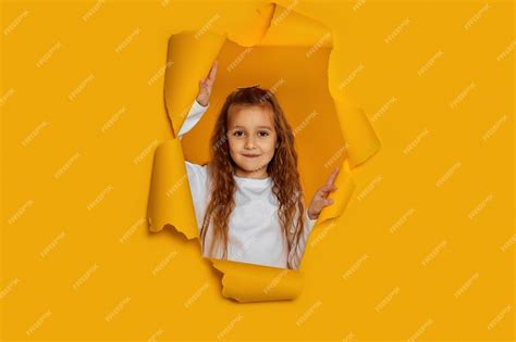 Premium Photo Portrait Of Cute Happy Smiling Caucasian Little Cild Girl Raises Clenched Fists