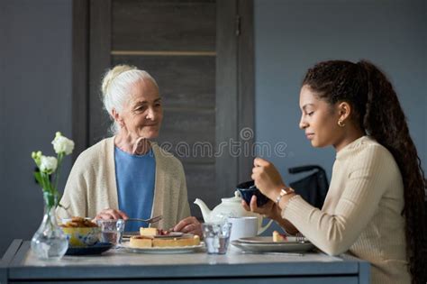 Kind Grandmother Looking At Her Granddaughter Eating Homemade Food Stock Image Image Of Dinner