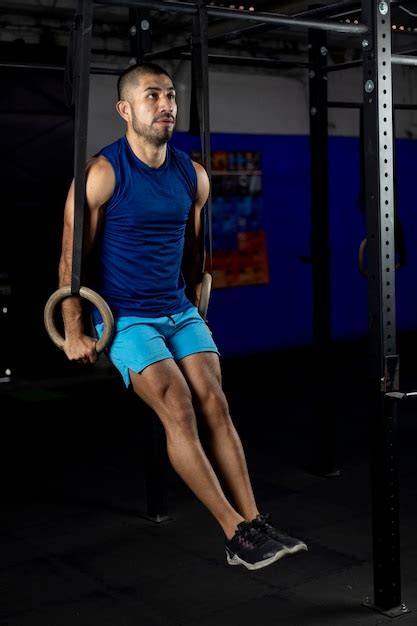 Premium Photo Vertical Shot Of A Gymnast Doing Ring Dips In The Haros Of A Gym