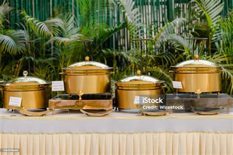 Closeup Shot Of A Buffet Style Meals In Closed Golden Cooking Pots