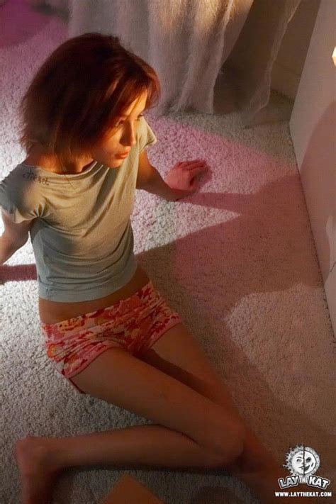 Seductive Young Redhead Posing In A Dimmed Intimate Light Porn Pictures