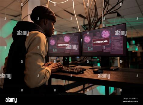 criminal cyberattack hacker accessing computer system man writing