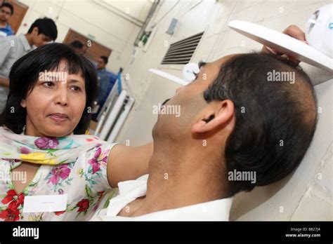 A Woman Measures The Height Of A Man As Part Of A Health Check Up Stock Photo Alamy