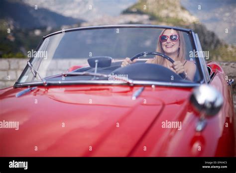 Young Woman Driving A Vintage Classic Sports Car In The South Of France