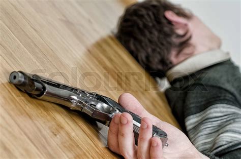 Man With Gun Laying On The Floor Stock Image Colourbox