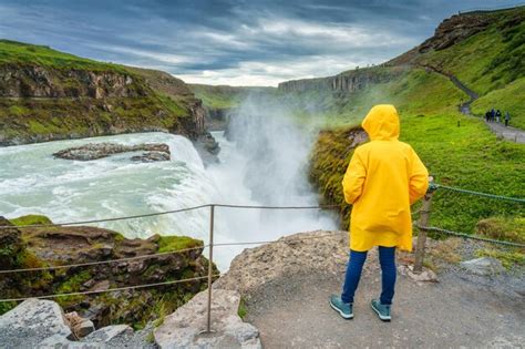 Premium Photo Female Tourist In Yellow Jacket Enjoying On Viewpoint