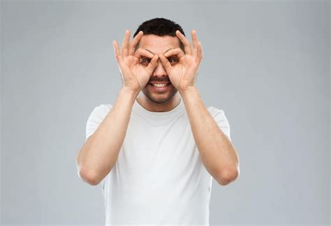 Premium Photo Fun And People Concept Man Making Finger Glasses Over