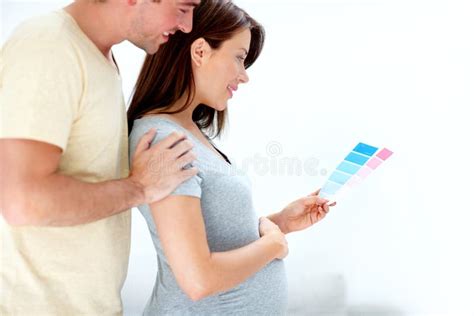 Is It A Boy Or A Girl Young Expecting Couple Holding A Pink And Blue