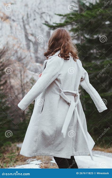 Vertical Shot Of The Female From Behind Standing In The Forest With