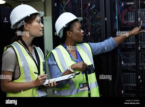 We Need To Troubleshoot This Two Attractive Female Programmers Working In A Server Room Stock