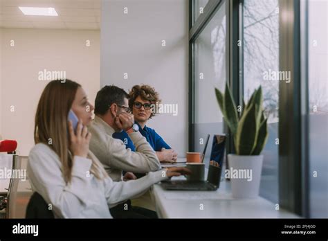 Middle Aged Male And Female Managers Discussing Solutions For The Project Problems Blonde