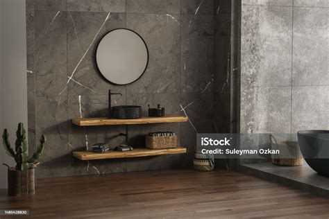 최소한의 목재 세면대 타원형 거울 검은색 세면대 대리석 세라믹 벽 콘크리트 바닥 식물과 바구니 욕실 액세서리 현대적인 무연탄 욕조가 있는 현대적인 욕실입니다 3d 렌더링 0
