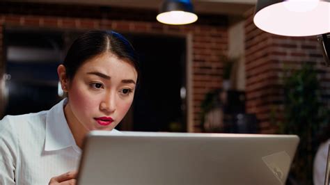businesswoman crosschecking data between stock footage sbv 348831063
