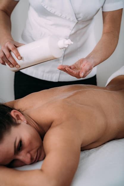 Premium Photo Midsection Of Massage Therapist Massaging Female