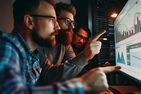 Three Colleagues Analyze Data On A Computer Screen Premium Ai