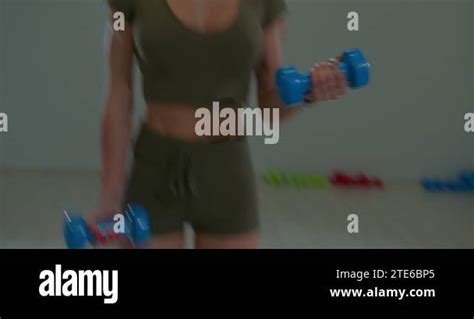 Athletic Shape Brunette Girl Performs Flexion Of Arms For Biceps Alternately Stock Video Footage