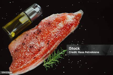 생선 음식 검은 색 배경에 연어 또는 송어 필렛 올리브 오일과 지방이 많은 생선은 오메가 3의 공급원입니다 건강한 라이프 스타일
