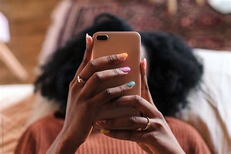 Unrecognizable Woman Scrolling On Her Phone By Stocksy Contributor Lucas Ottone Stocksy