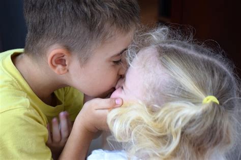 Premium Photo Close Up Of Siblings Kissing At Home