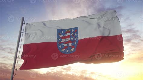 Thuringia Flag Germany Waving In The Wind Sky And Sun Background 3d