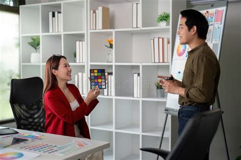 Graphic Design And Collaboration Team Members Discussing Color Choices In A Contemporary Office