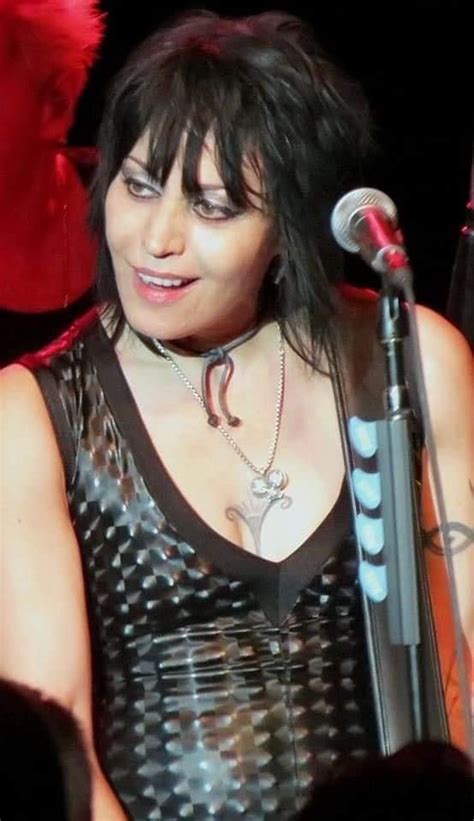 A Woman Standing In Front Of A Microphone