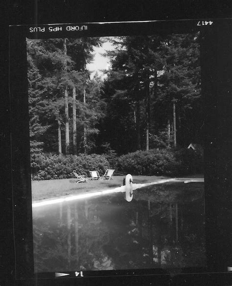 Surreal Black And White Photo Of A Pool With Lawn Chairs Water