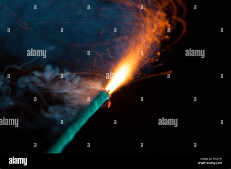 Burning fuse with sparks and blue smoke on black background Stock Photo - Alamy